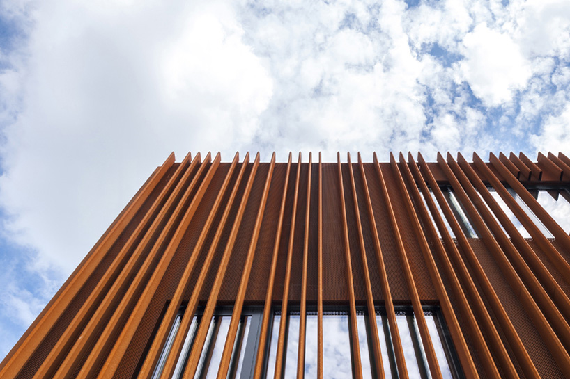 DMOA architecten forges corten house from weathering steel lamellae
