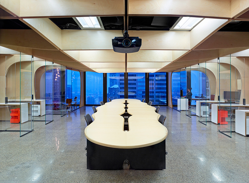 partisans delineates office space with a waffle of plywood surfaces