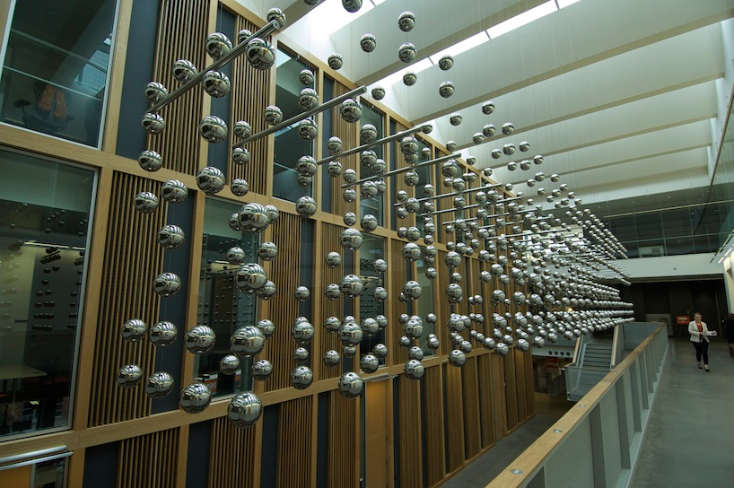 abacus sculpture by ray king floats polished spheres of stainless steel