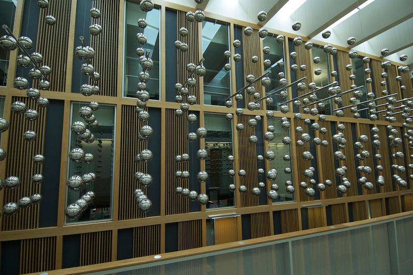 abacus sculpture by ray king floats polished spheres of stainless steel