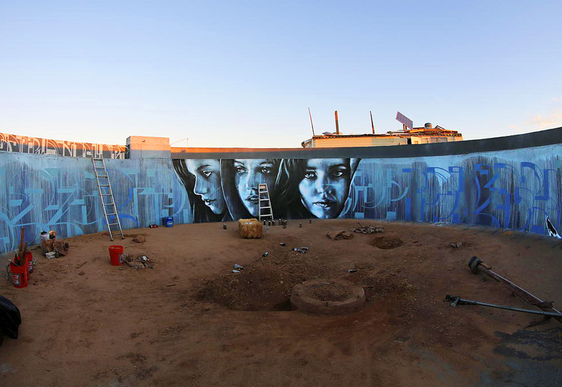 Learner's Club — Artists paint circular mural inside an abandoned...