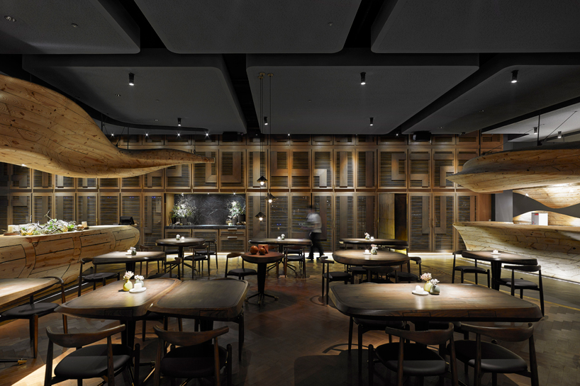 weijenberg weaves sculpted timber element around RAW restaurant in taipei