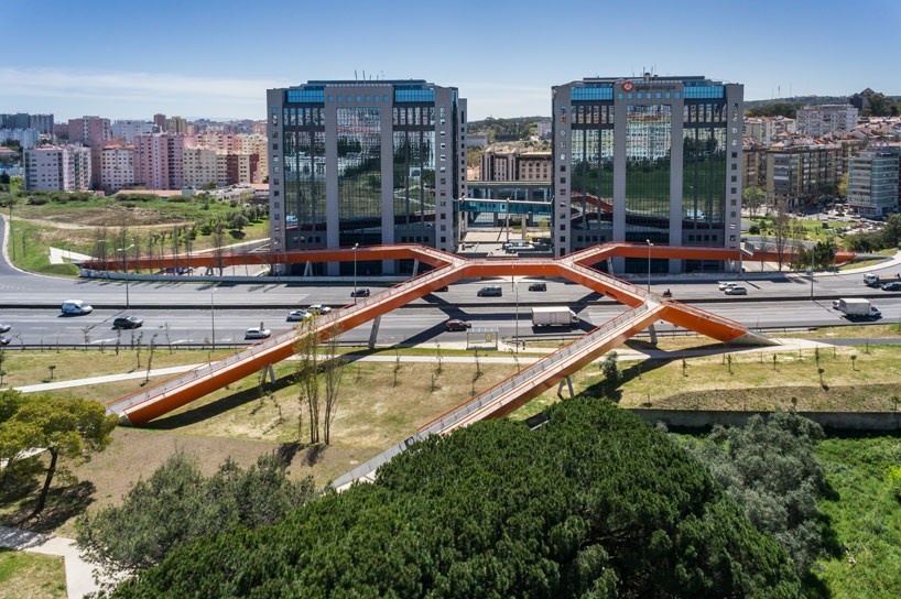 maximina almeida + telmo cruz overlap orange steel bridge above highway ...