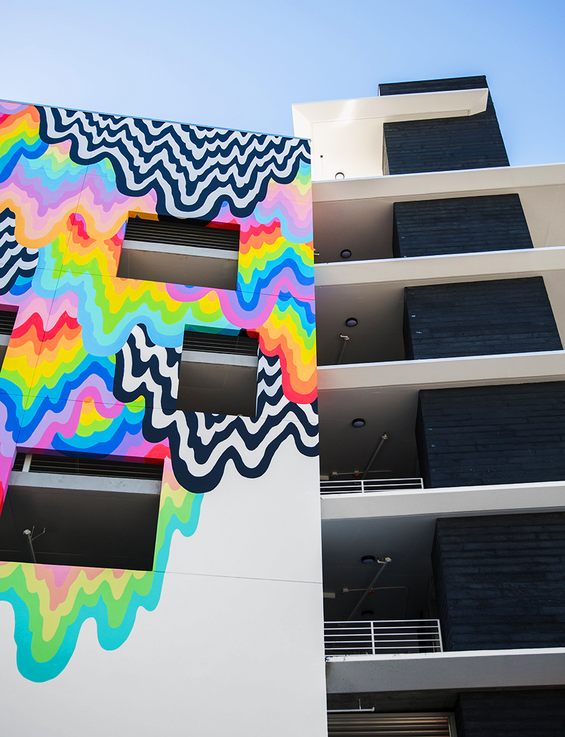 jen stark oozes drippy, technicolor mural across california building façade