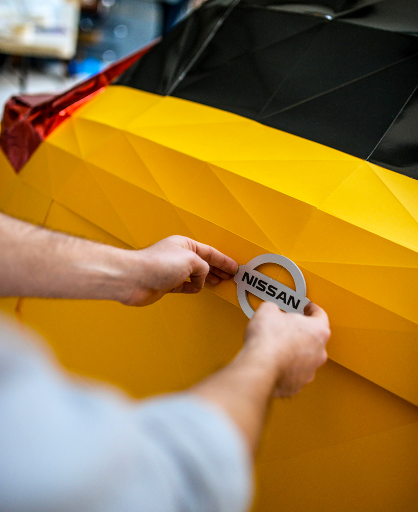 nissan forms full-size origami car with 2,000 folded paper sheets