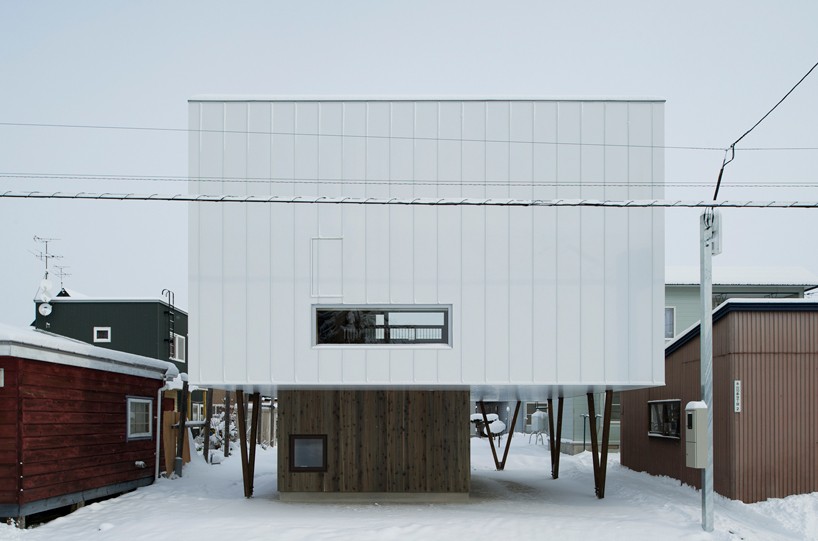 archi LAB uses pilotis to elevate japanese home from rising snowfall