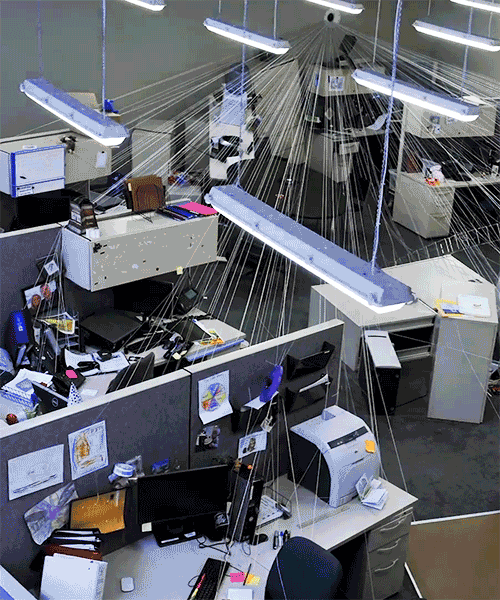 these office cubicles are sucked into a tiny hole in the wall
