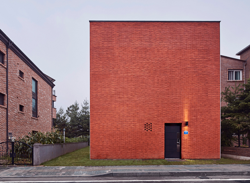 subverting the common red brick façade, archiworkshop creates a ...