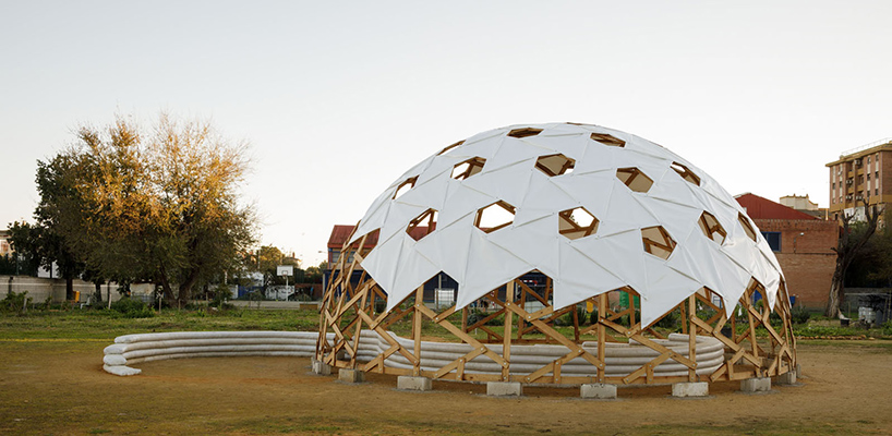 collaborative team builds twin geodesic domes in an orchard