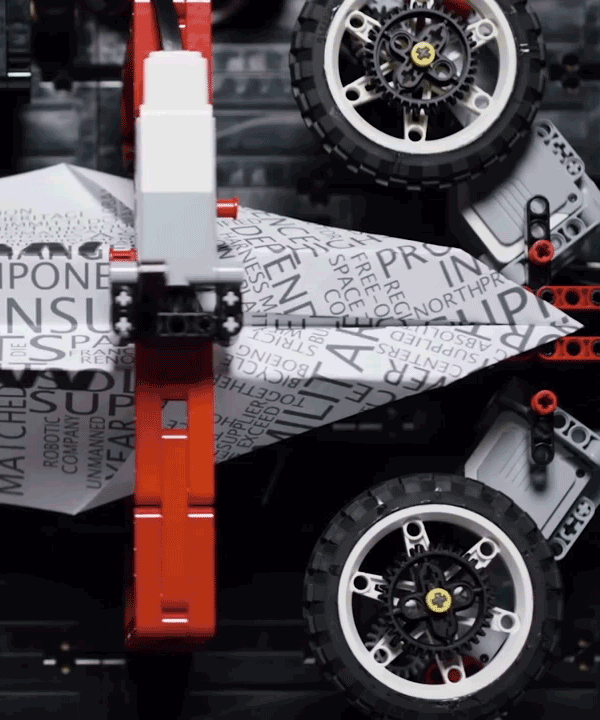 handmade LEGO robot folds + launches paper planes to perfection