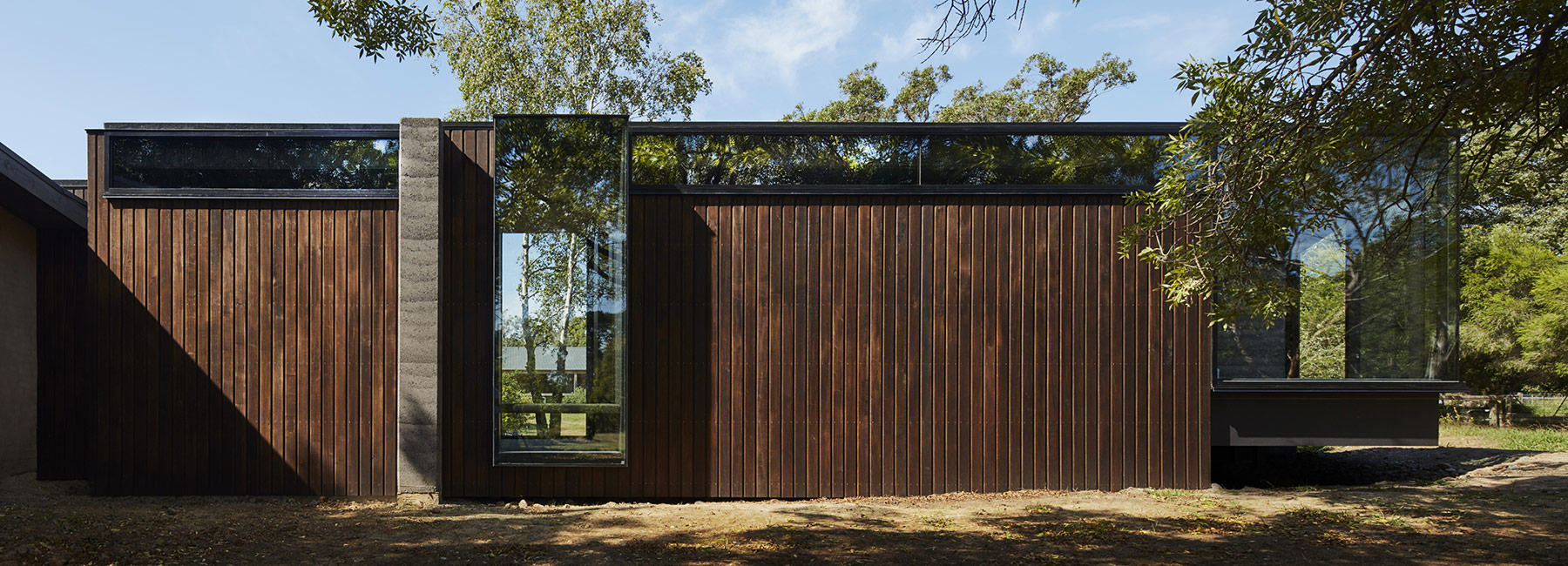 branch studio architects extends family home with a pavilion between trees