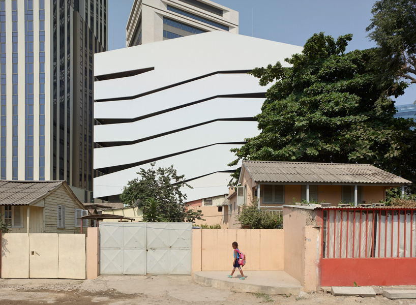 occupying all of the available land, the building features narrow ...