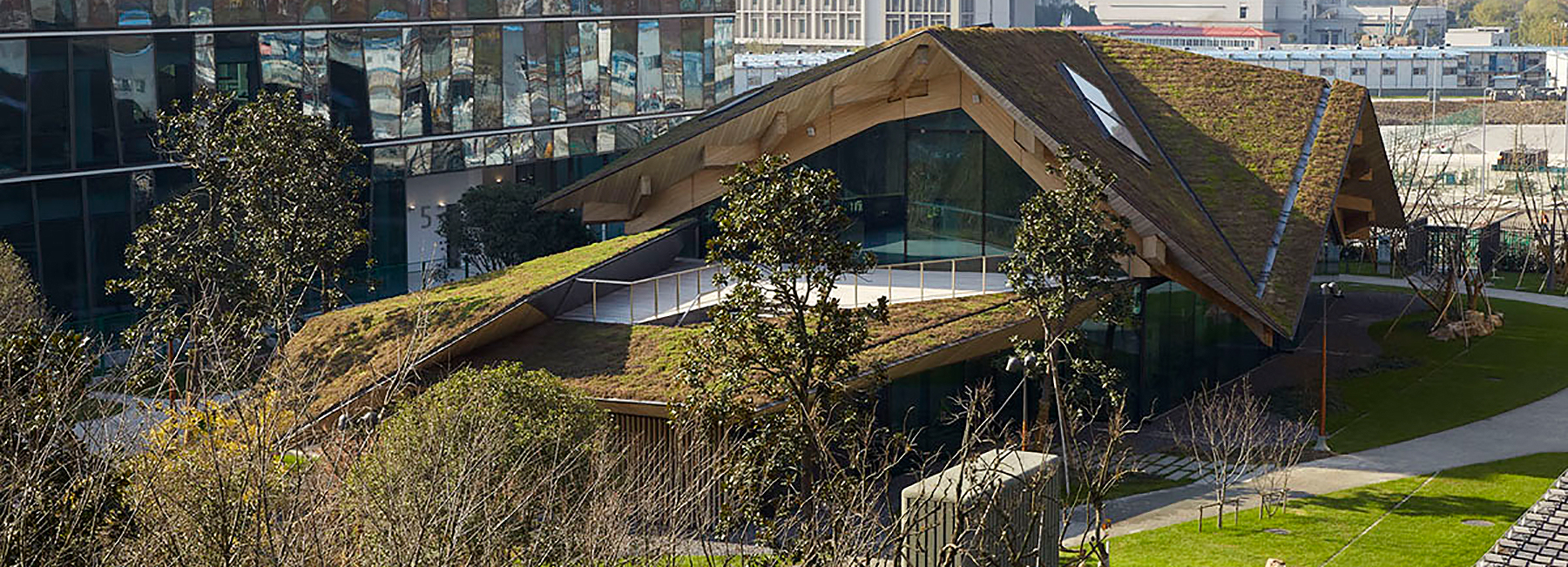 kengo kuma tops novartis building in shanghai with folded green roof