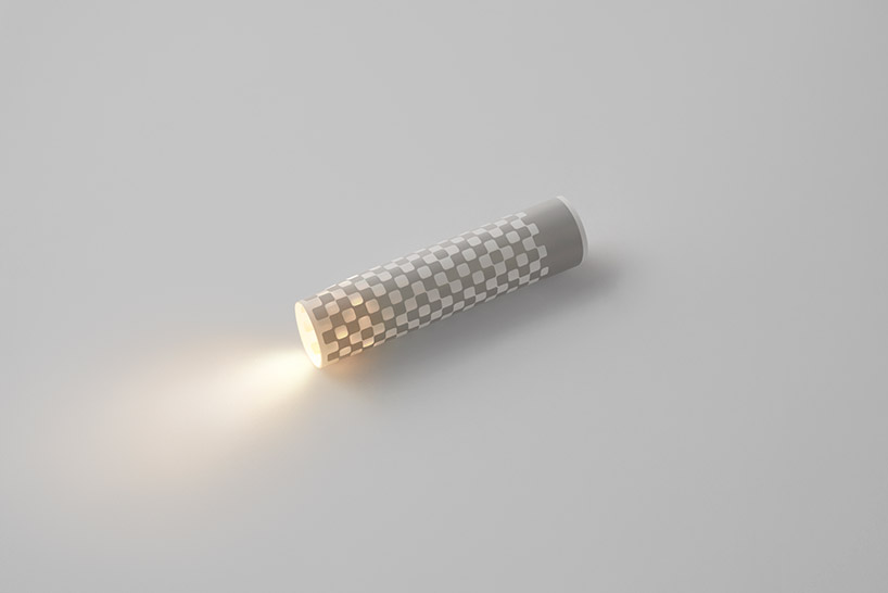 nendo's paper torch is an electronic paper that rolls itself up into a lamp