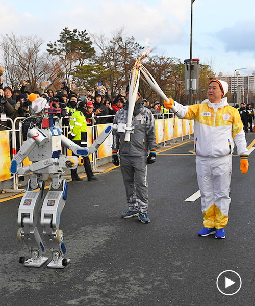 robots carry the olympic torch ahead of south korea winter games 2018