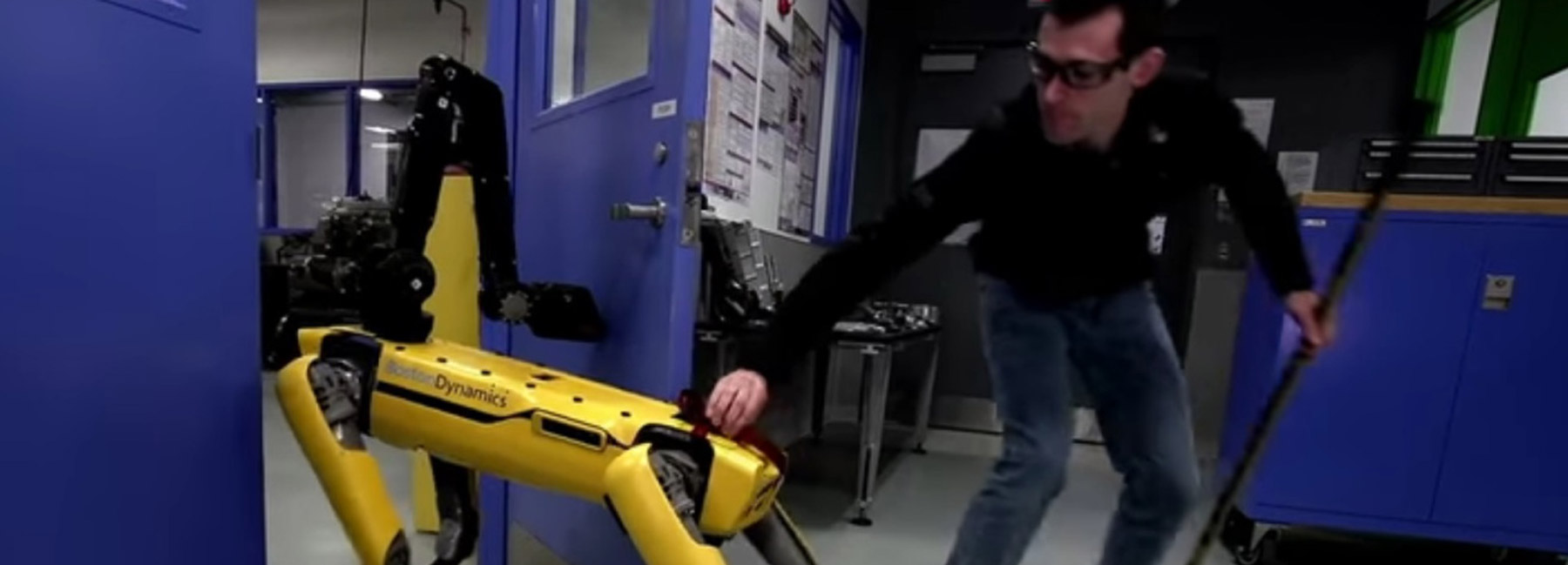 poor robot dog faces abuse just trying to walk through a door