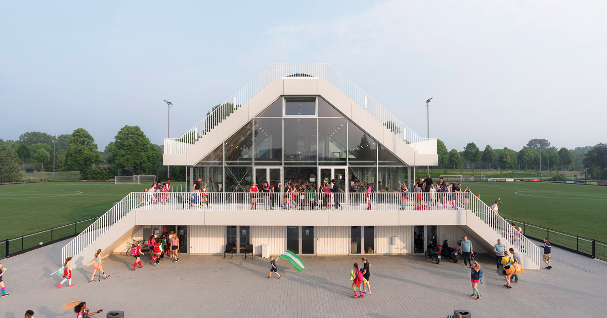 this sports center by NL architects features a pitched roof and grandstand
