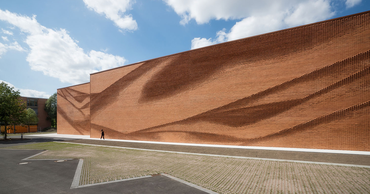 this undulating brick façade imitates the movement of draped fabric