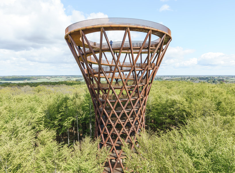 spiraling observation tower by EFFEKT soars above the trees of a danish ...