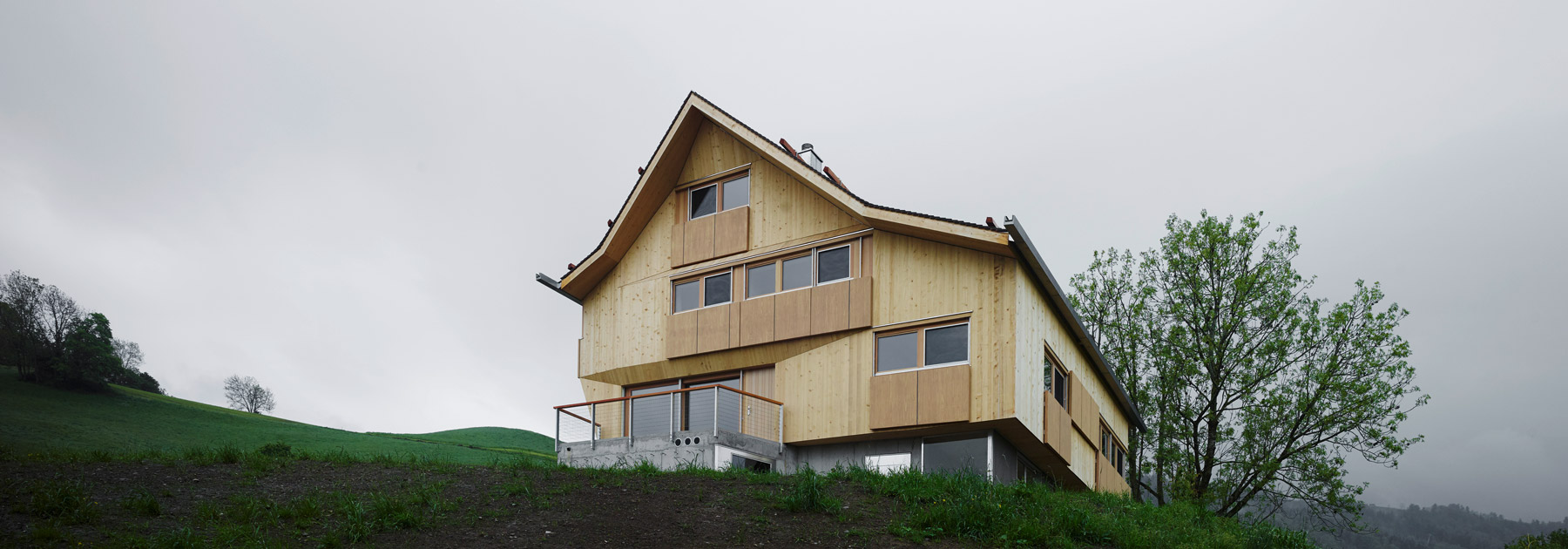 AFGH folds an asymmetrical roof over 'house ribetschi' in rural switzerland