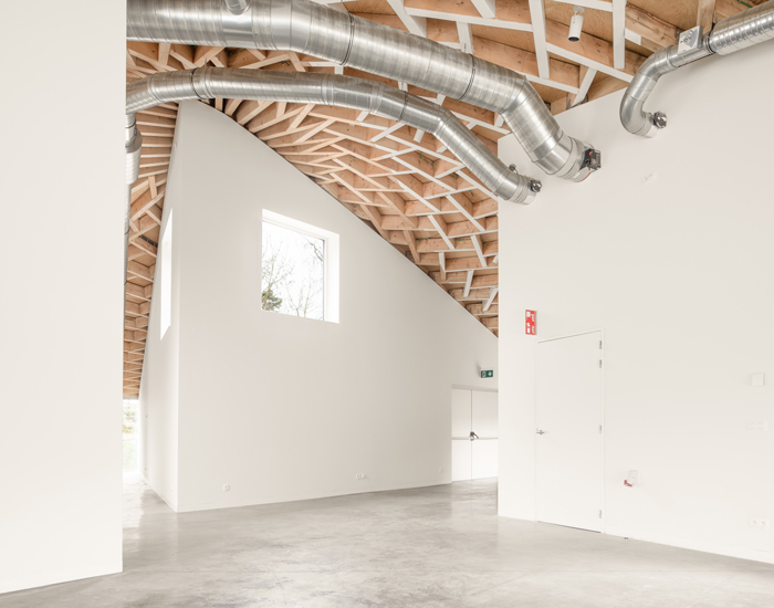 a conic roof of complex timber tops frans masereel centrum in belgium a ...