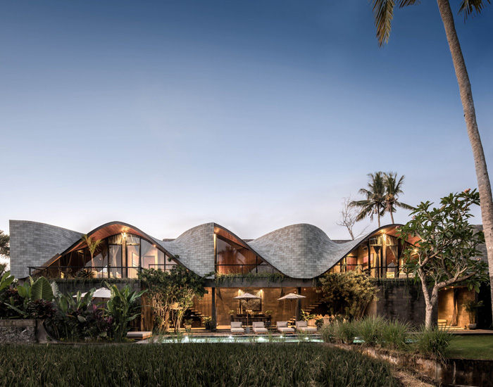 its form echoes the rolling mountainscape of bali in the background.
