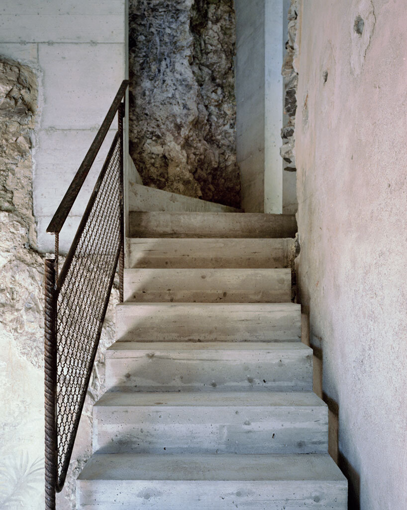 enrico sassi revives grotto ruin embedded into the cliffs of switzerland