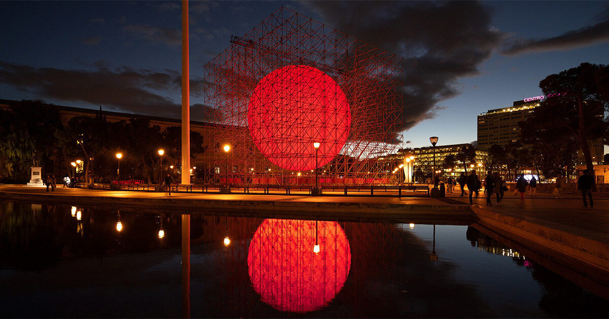 SpY cages huge luminous red sphere within scaffolding structure in madrid