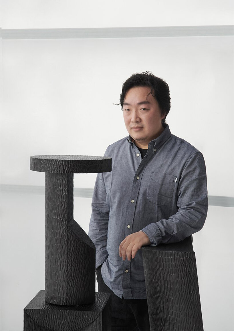 ren hongfei's monolithic stools embrace organic forms of wood logs