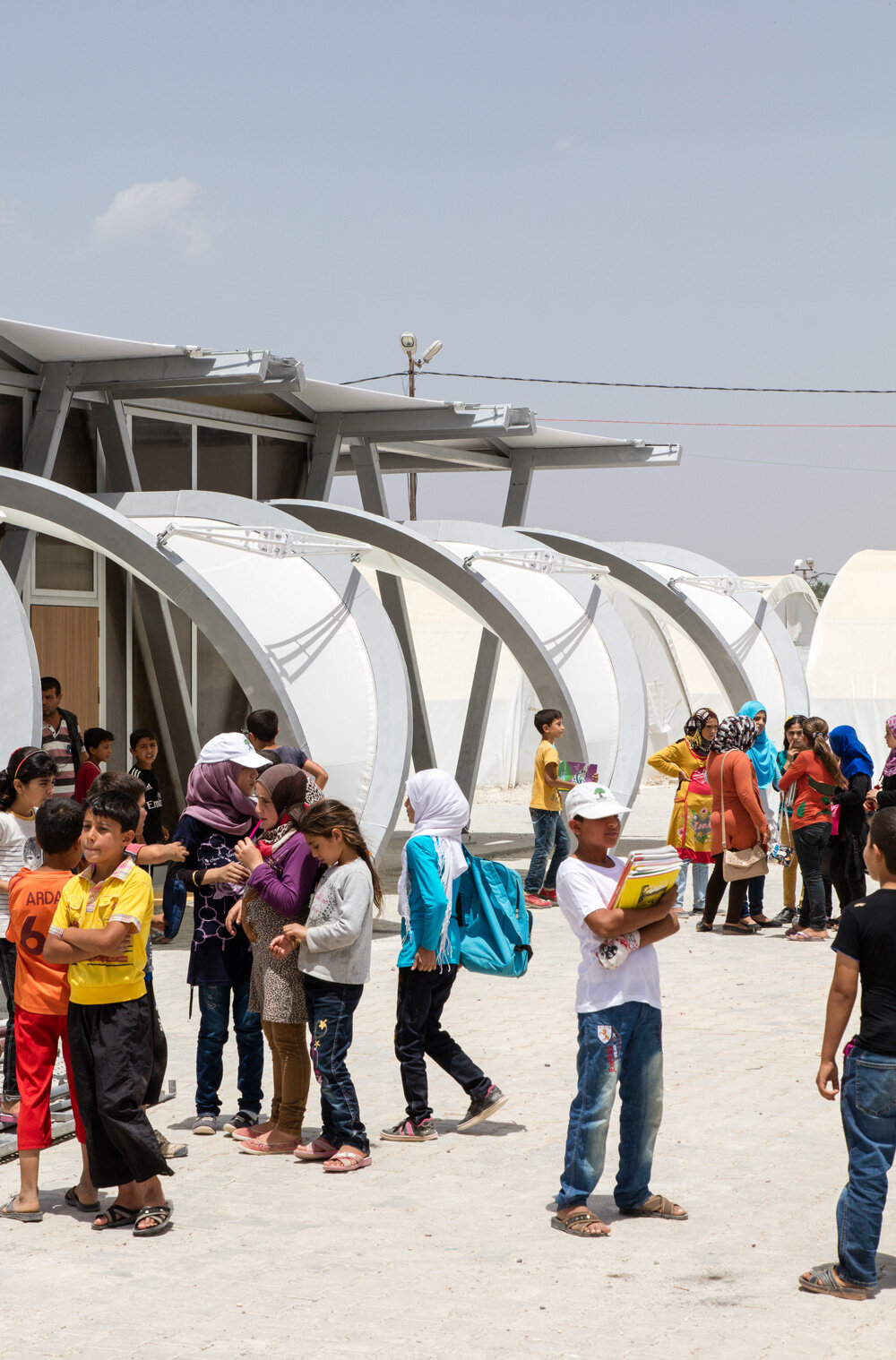 zaha hadid designs 27 tents as schools, clinics and shelters for refugee communities