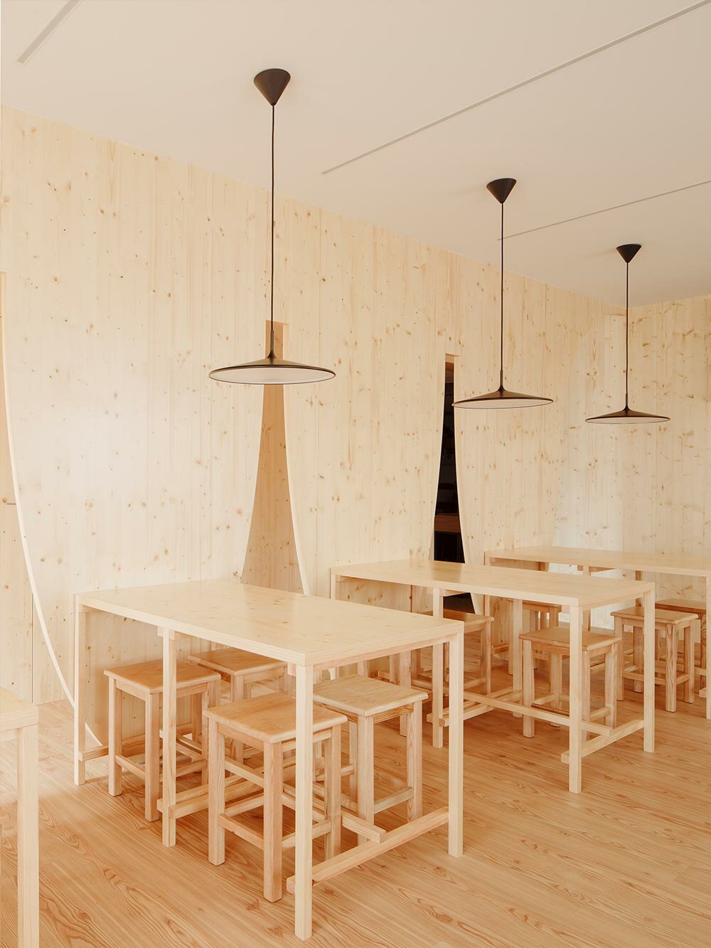 funnel-shaped cutouts finish snug restaurant in portugal