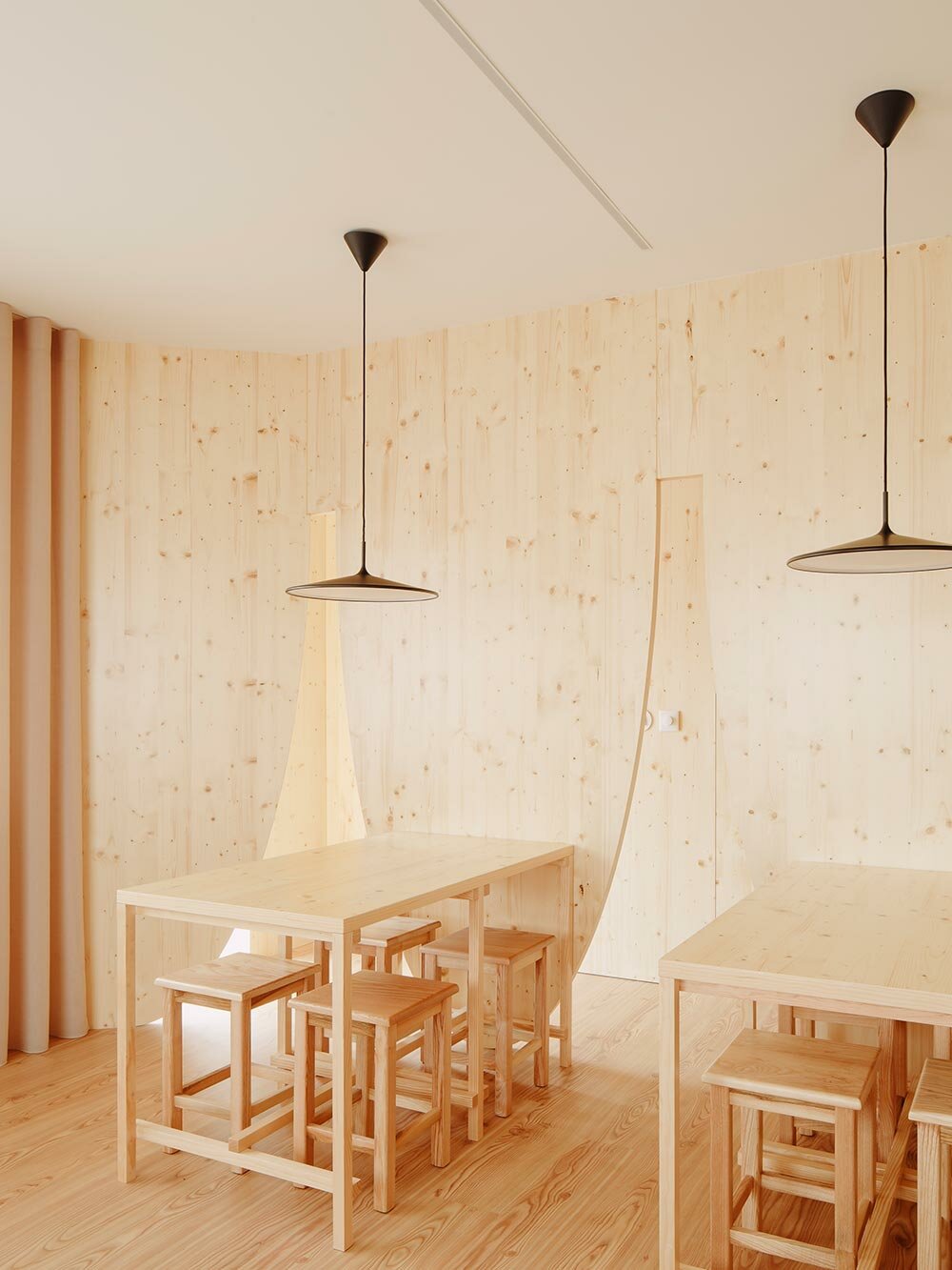 funnel-shaped cutouts finish snug restaurant in portugal