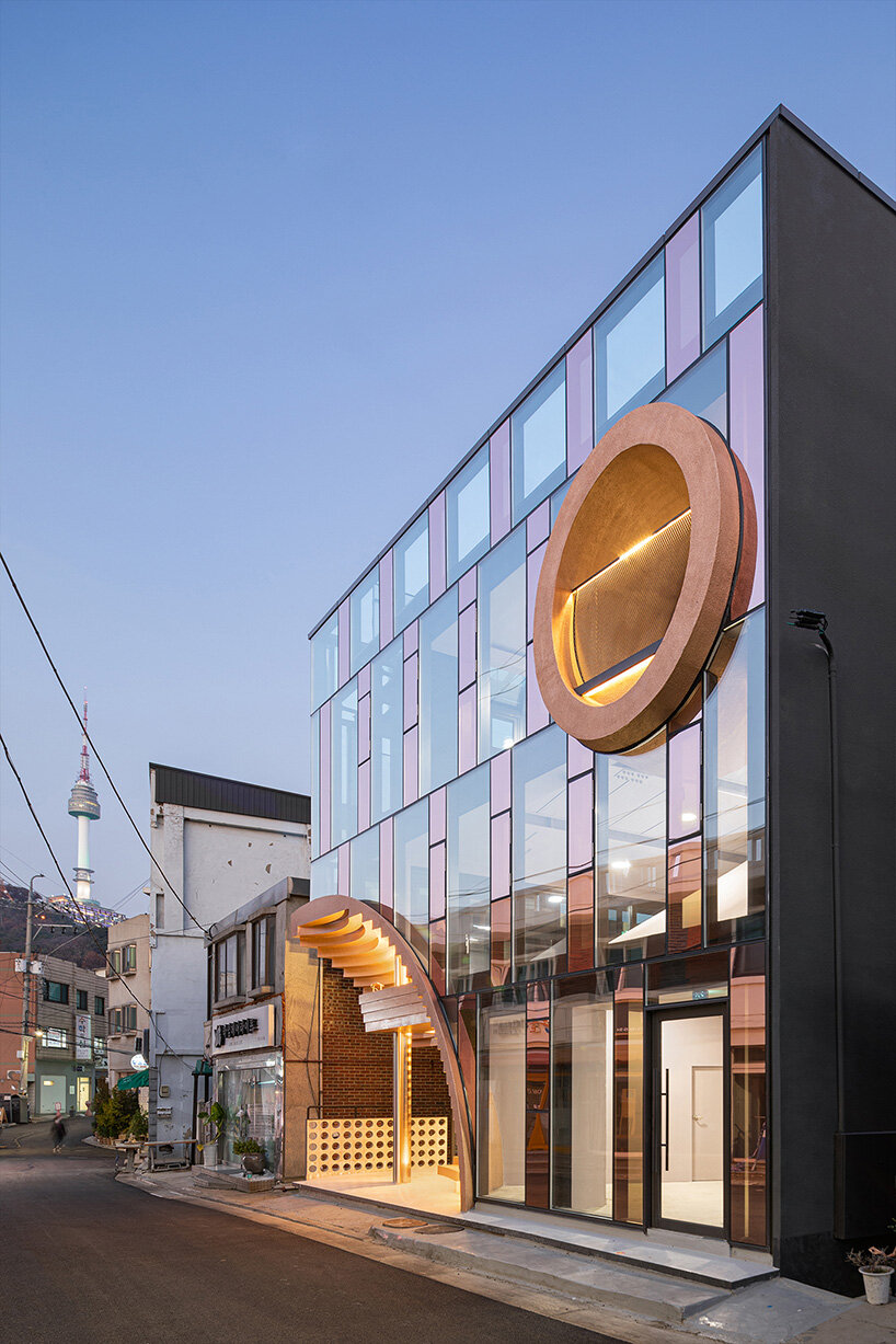 concrete cuts + curves adorn the 'diagon' building by moon hoon