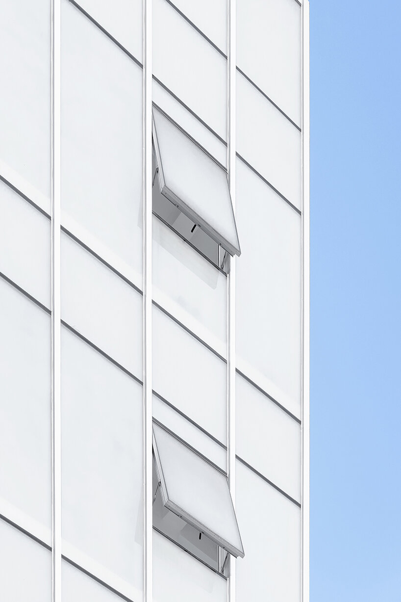 greater dog architects adorns mixed-used building with feather-shaped ...