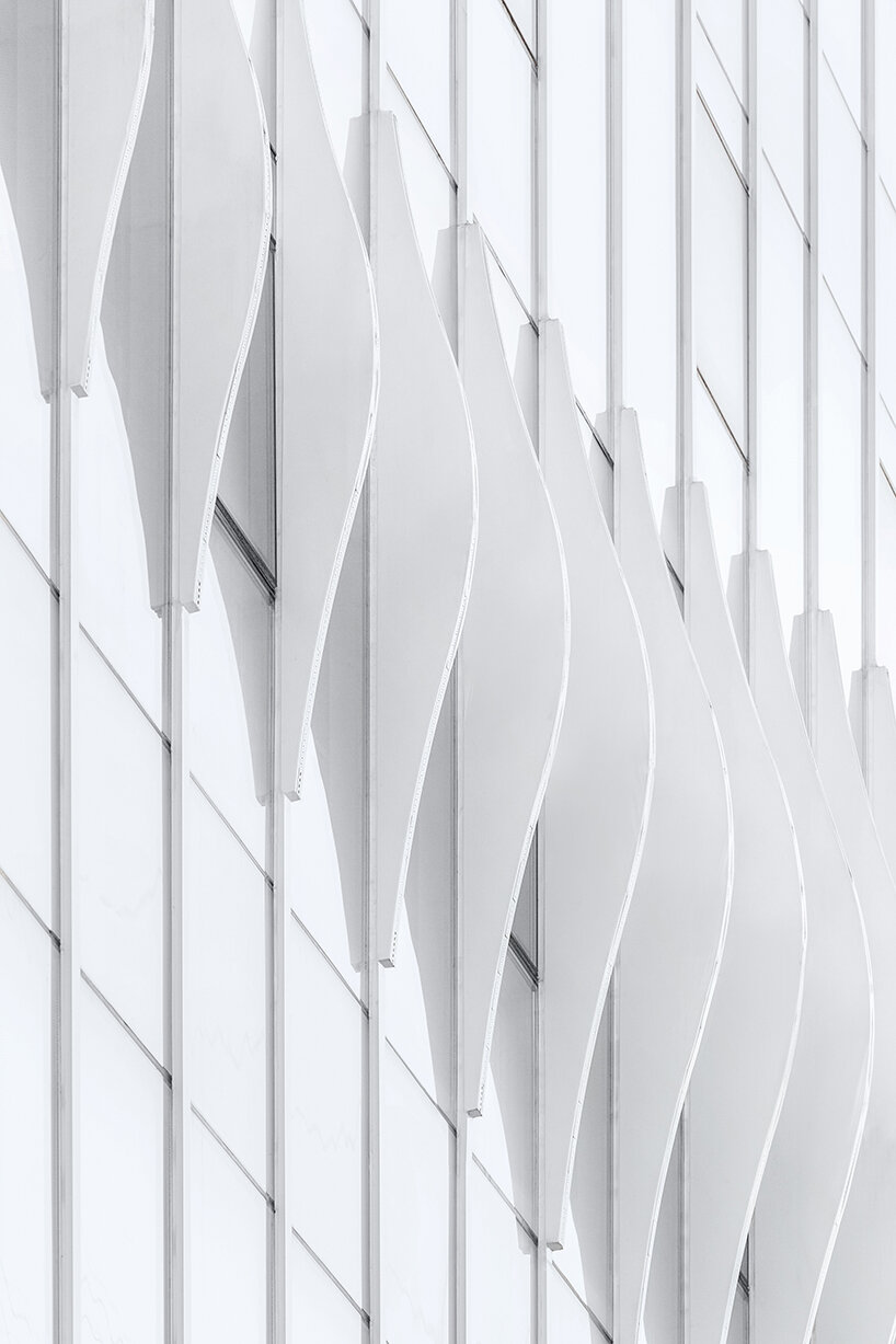 greater dog architects adorns mixed-used building with feather-shaped ...