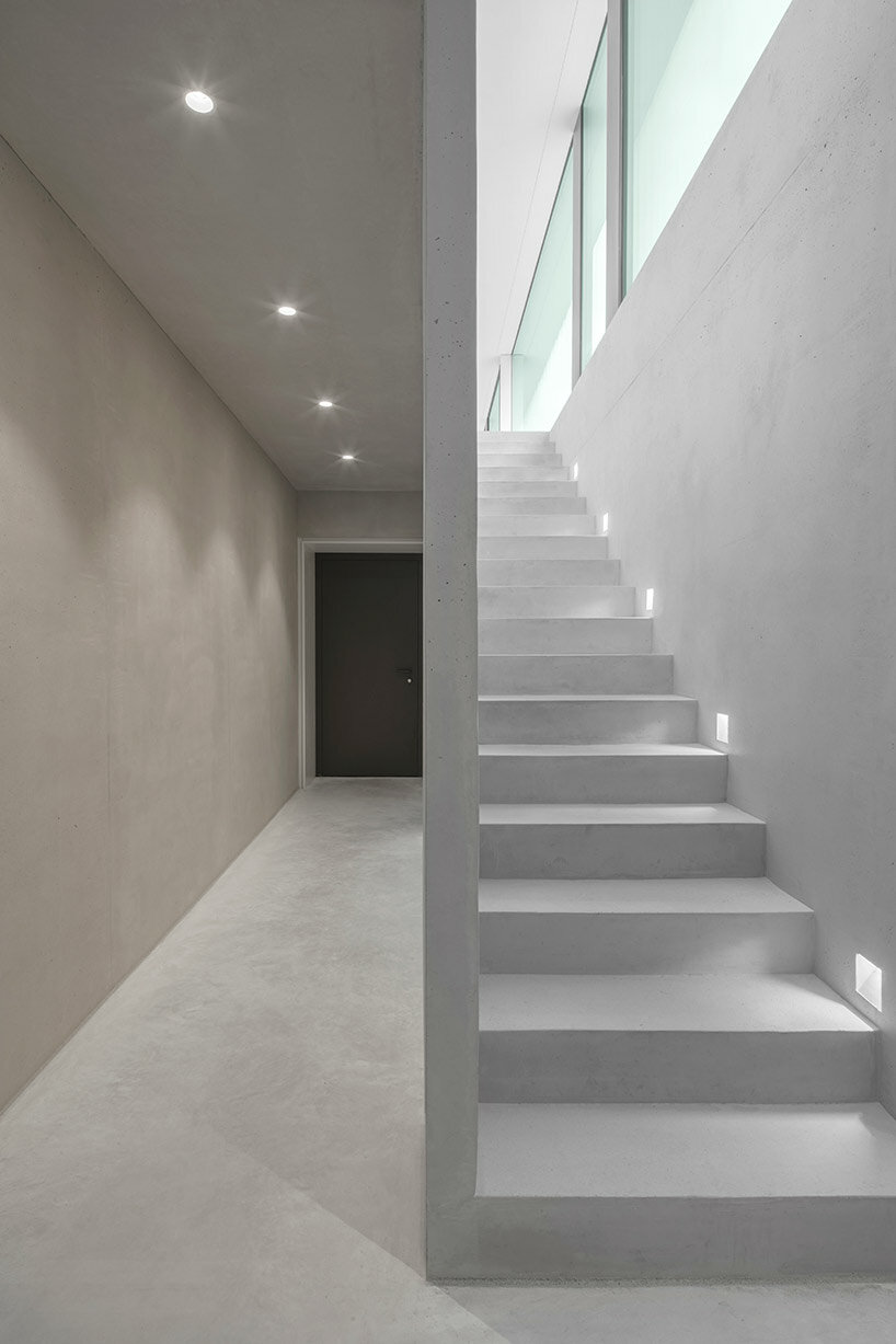 cantilevered concrete house by bergmeisterwolf emerges as a monolith ...