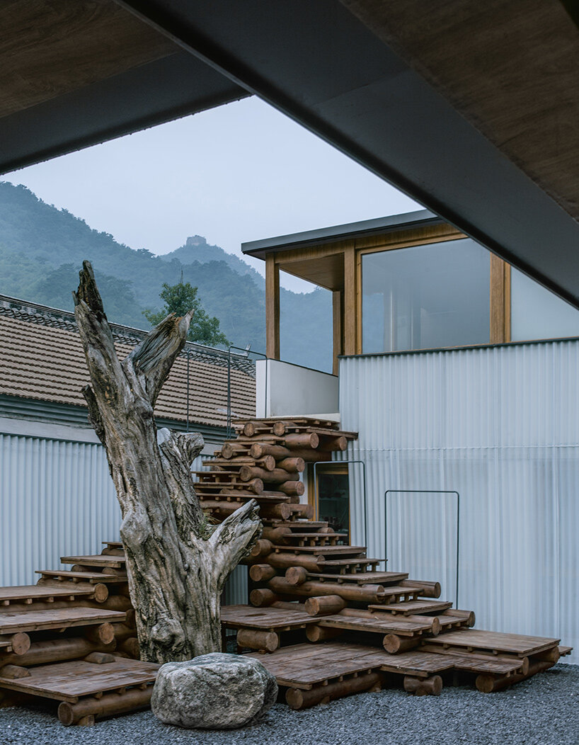 a contemporary inn is hidden within an ancient city near china's great wall