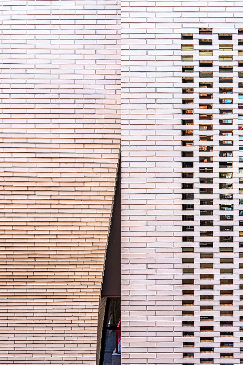 a curved brick wall ripples across LESS architects' office building ...