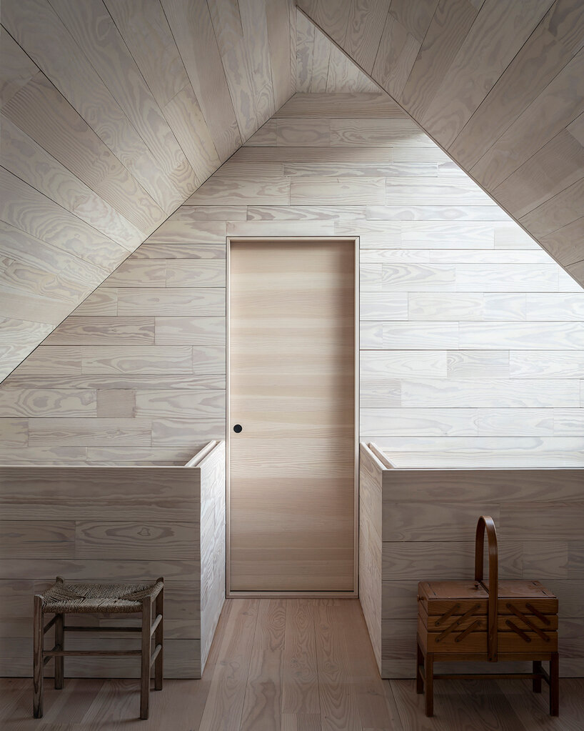 a house made of oak plank offcuts stands on norway's coast
