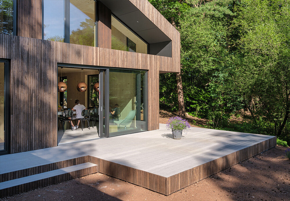 protruding windows bring nature inside spee architecten's sustainable ...