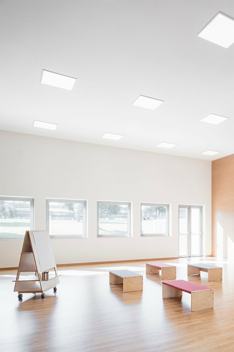 vibrant multipurpose room breathes new life into kindergarten in italy