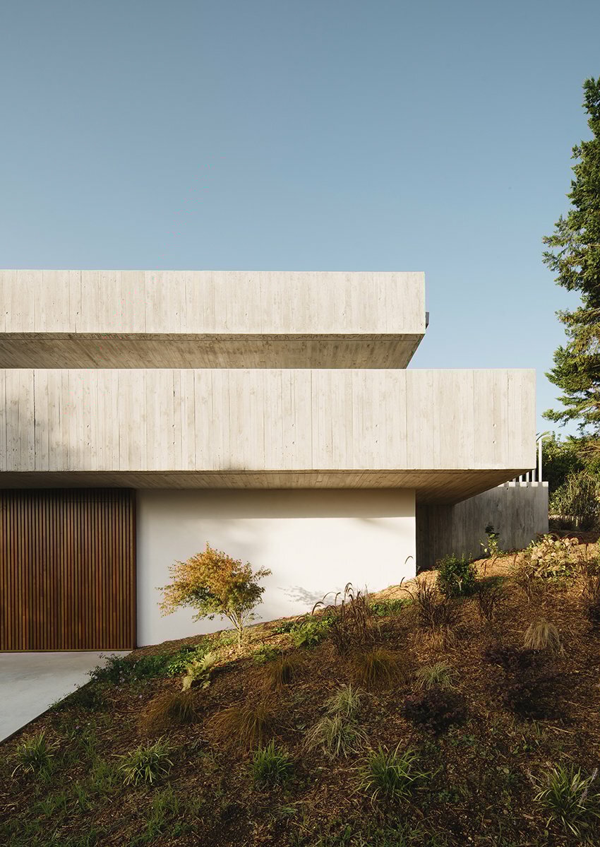 two concrete planes cantilever above the living zones of hara house in ...