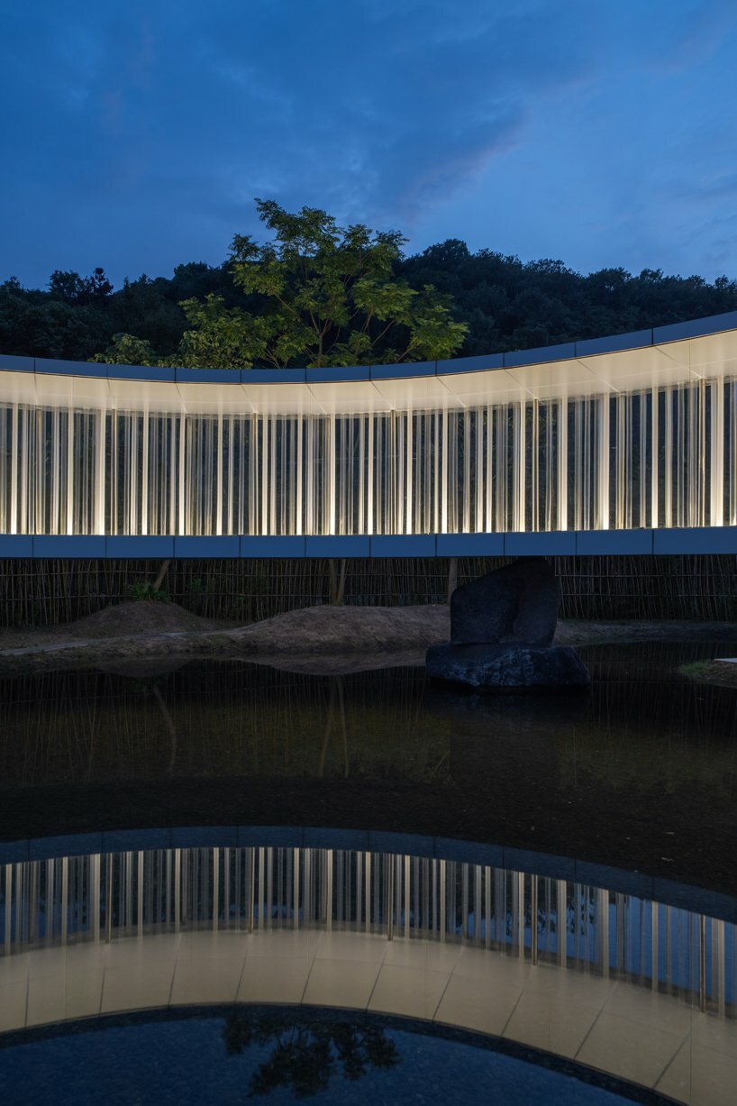 curved bridge corridor links two historic houses on chinese lakeside