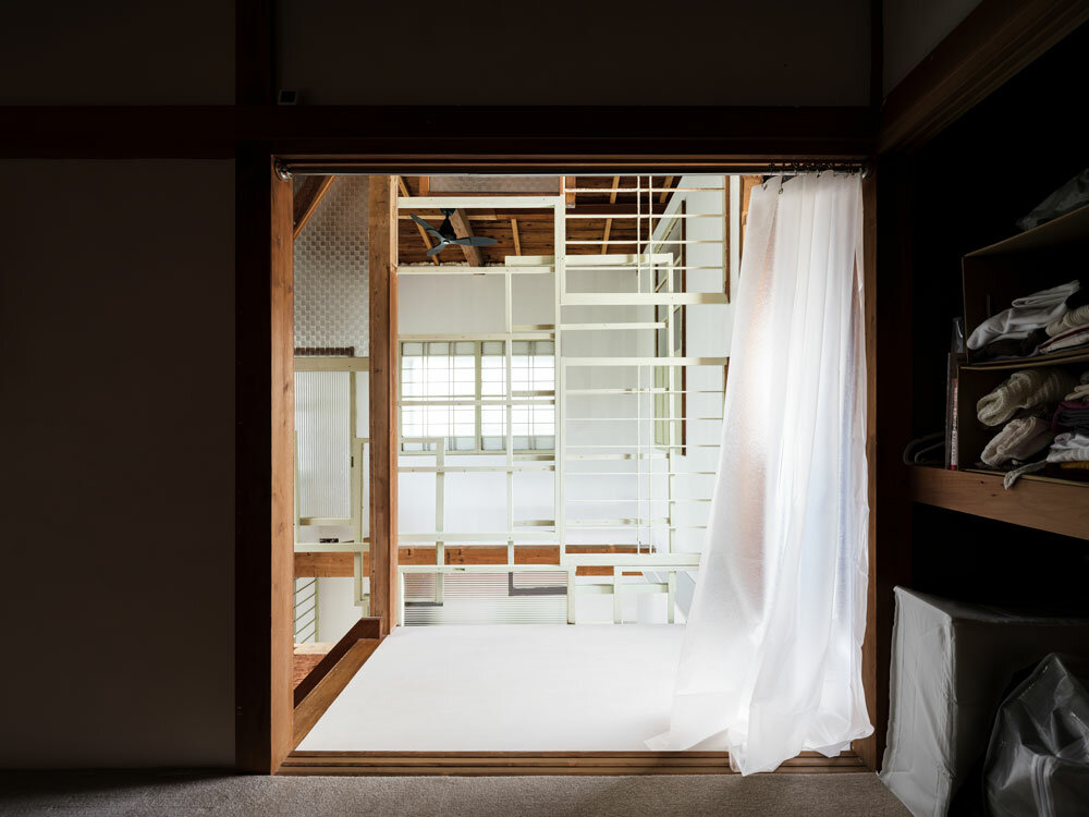 repurposed window frames add a splash of brightness to OTA's house in japan