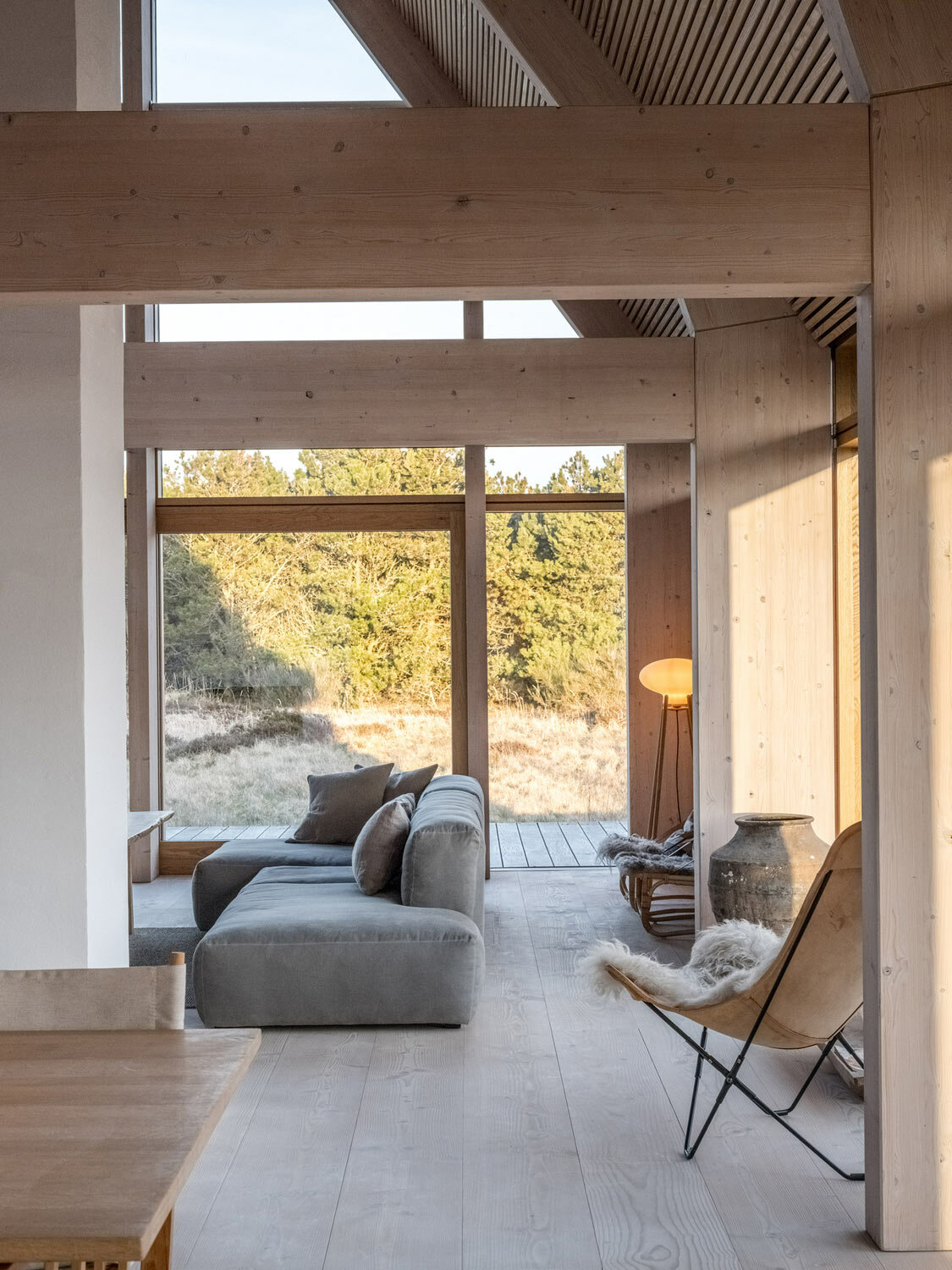 a thatched roof floats over PAX architects' skagen klitgård house