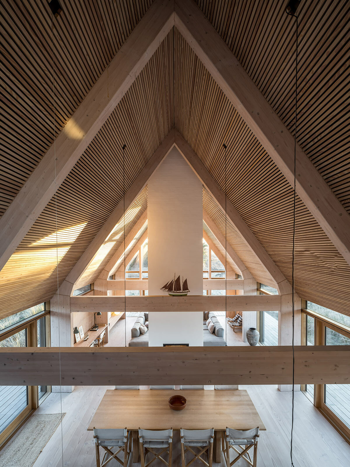 a thatched roof floats over PAX architects' skagen klitgård house