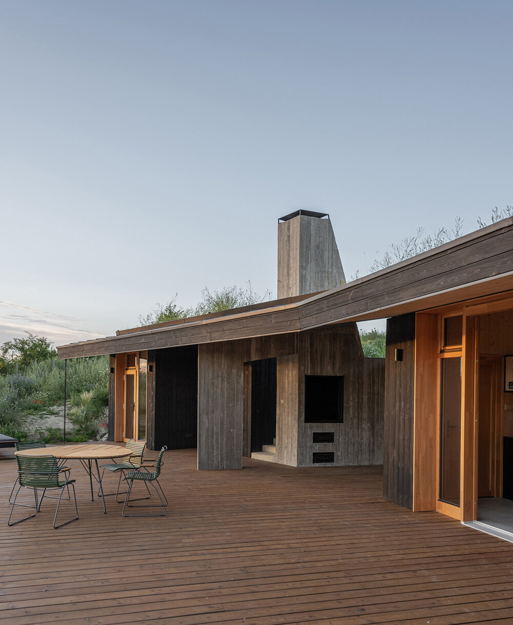hello wood's CLT house gently peeks out amid rural flora in hungary