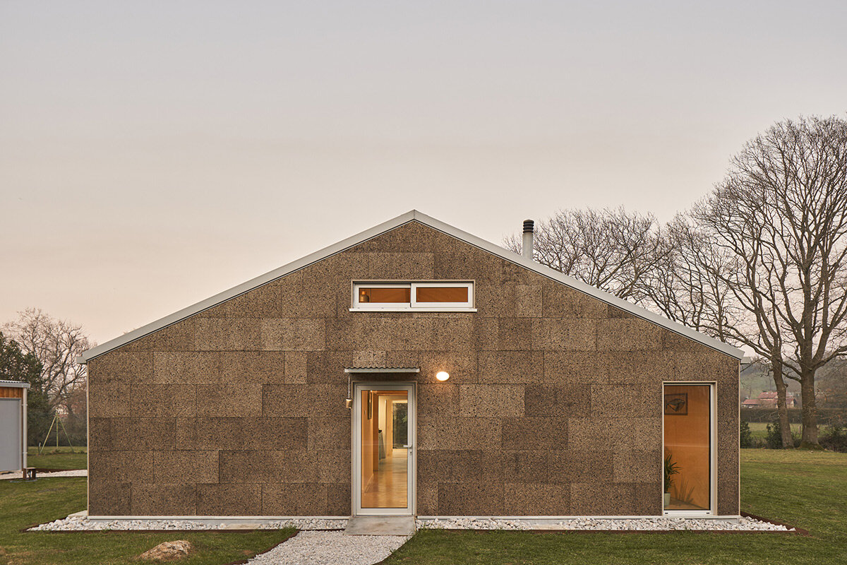 a cork and wood house is built by gurea arquitectura cooperativa