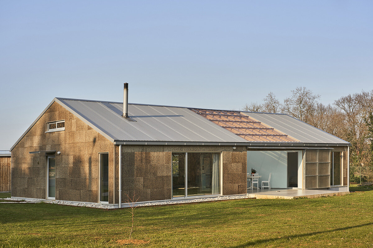 a cork and wood house is built by gurea arquitectura cooperativa