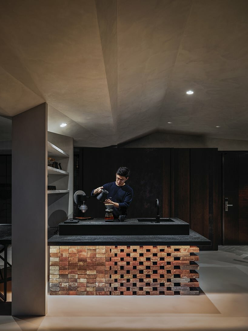multifaceted concrete ceiling floats above residential space in taiwan